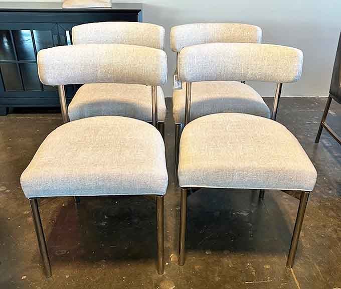 These sleek, cream-upholstered dining chairs aren't just seating—they're time machines to the Mad Men era when martinis were lunch and style was everything.