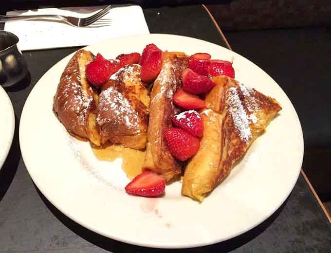 Challah French toast that turns breakfast into an event worth getting dressed for. Those strawberries aren't garnish&mdash;they're trying to elevate themselves through association with greatness.