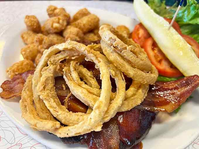 Golden onion rings so perfectly crispy they could double as edible jewelry for your bacon-wrapped dreams.