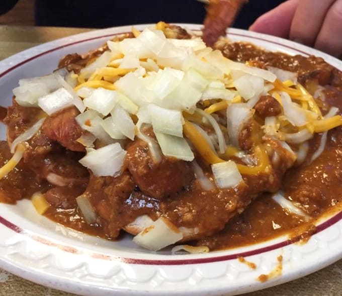 Chili, cheese, onions, and jalapeños create a flavor explosion that demands multiple napkins.