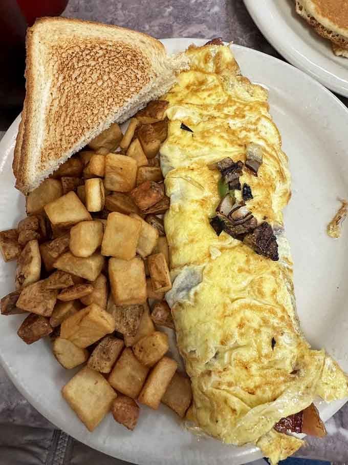 That omelet is so perfectly folded it deserves its own standing ovation and a side of applause.