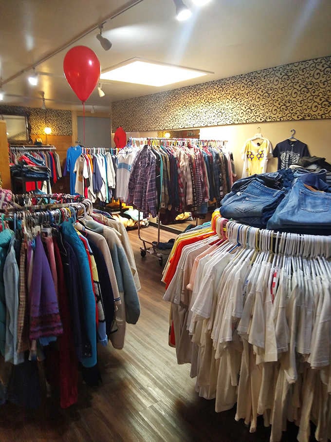 Not your average clothing rack! These vintage threads have stories sewn into every seam, with red balloons adding a touch of celebration.