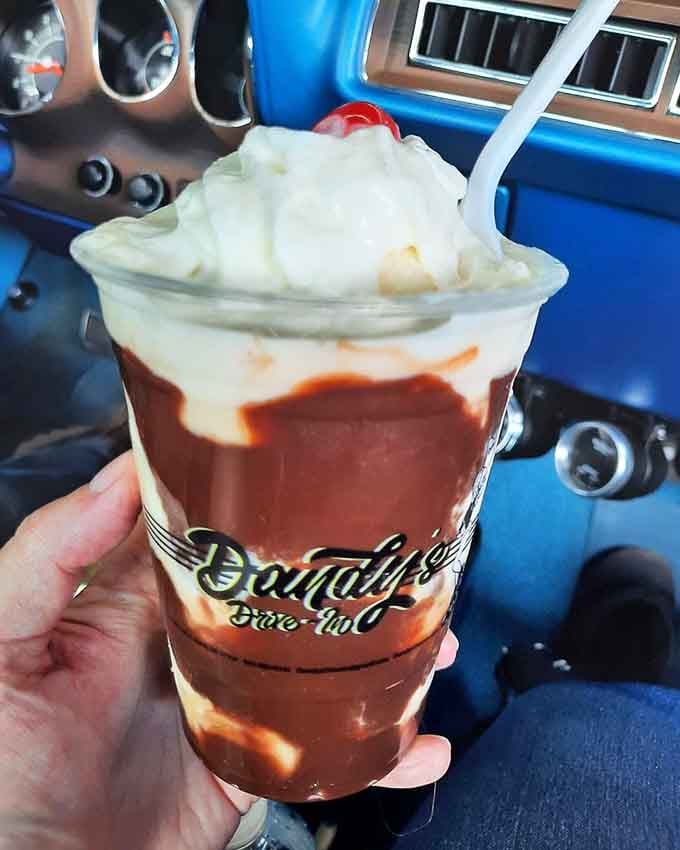 Whipped cream peaks over chocolate swirls like a delicious mountain range, this sundae means serious business about dessert.