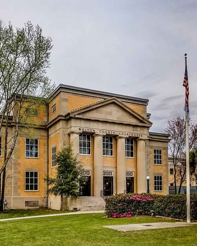 The Walton County Courthouse stands proud in butter-yellow glory, looking like it could settle any dispute with pure Southern charm.
