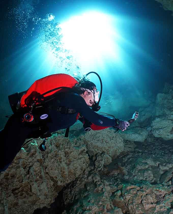 Diving through crystal-clear water with sunbeams as your spotlight, because regular pools are just too mainstream for some folks.