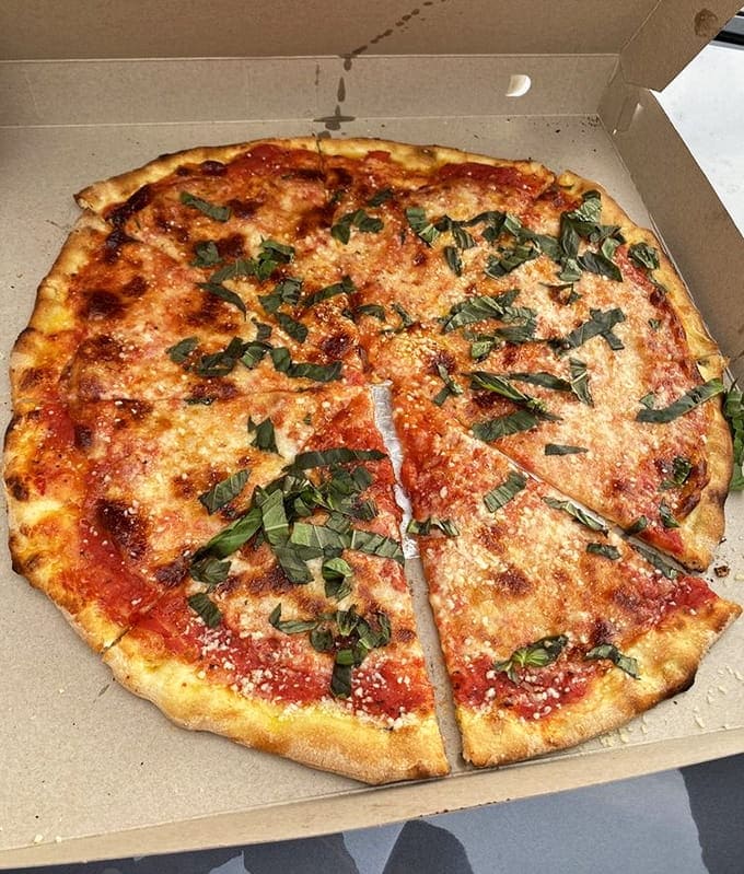 Fresh basil and that legendary olive oil drizzle transform simple ingredients into something approaching religious experience territory.