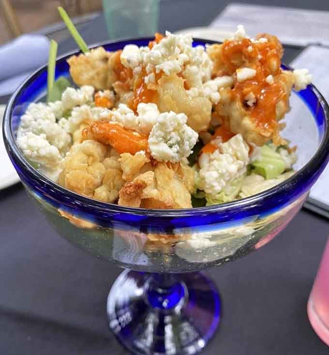 Fried oysters served in an elegant glass prove that presentation matters almost as much as flavor does.