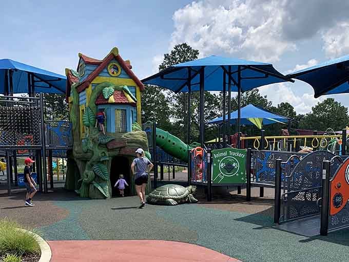 Blue shade canopies provide relief from the sun while kids tackle every climbing challenge in sight.