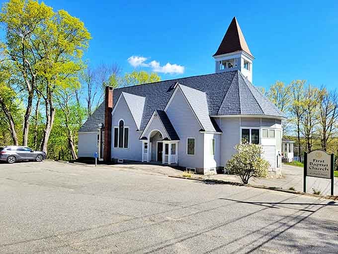First Baptist's white steeple reaches skyward, a spiritual landmark where Sunday best meets everyday faith in classic New England style.