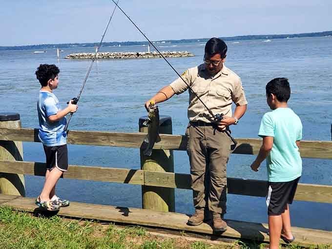 Passing down the ancient art of patience. A park ranger shares fishing wisdom with young anglers, creating memories more valuable than any catch.