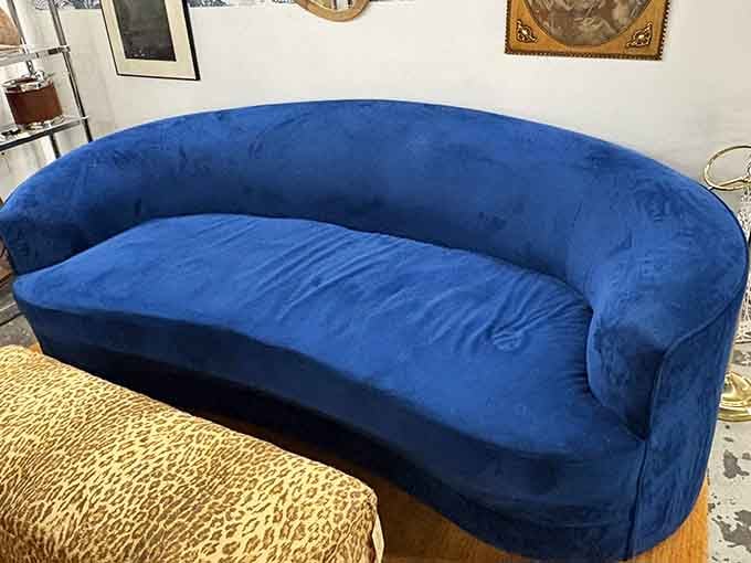 That blue velvet sofa is giving serious Studio 54 vibes, minus the questionable life choices and plus maximum comfort.
