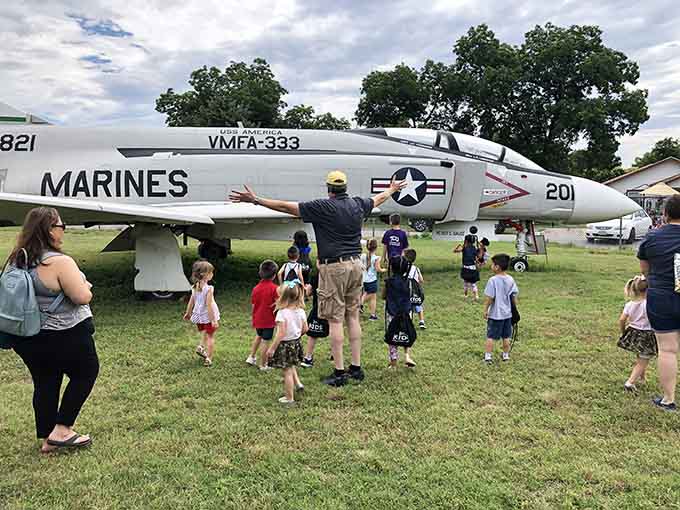 Families gather around a Marine Corps fighter, proving that aviation history captivates every generation equally and enthusiastically.