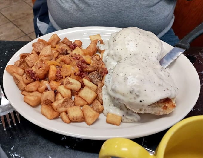 The Hoosier Benedict smothered in creamy sausage gravy is Indiana comfort food at its absolute finest.