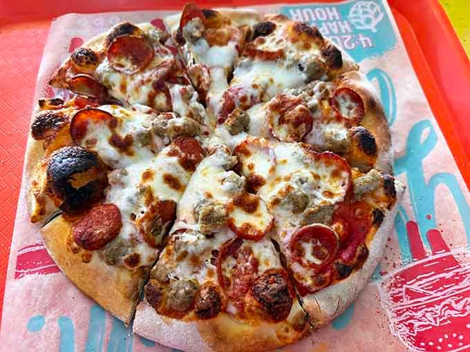 Pepperoni and sausage loaded on a personal pizza that's charred just right for maximum flavor impact.