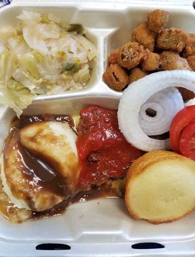 That meatloaf glistening with gravy alongside perfectly fried okra and tender cabbage is pure comfort on a styrofoam plate.