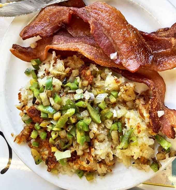 Hash browns and bacon&mdash;the breakfast equivalent of Astaire and Rogers, dancing together in perfect, crispy harmony on this no-frills white plate.