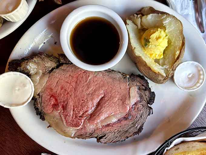 Prime rib sliced thick with that perfect pink center, proving simple done right beats complicated done wrong.