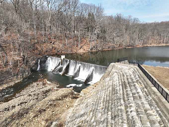 Water cascades over the dam in perfect white sheets, nature's own power display running on autopilot for centuries.