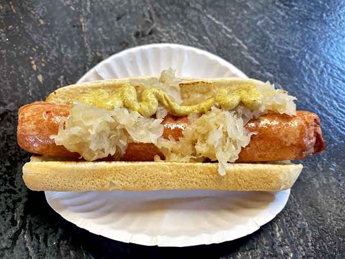 Sauerkraut and mustard on a deep-fried dog, because sometimes traditional toppings know exactly what they're doing.