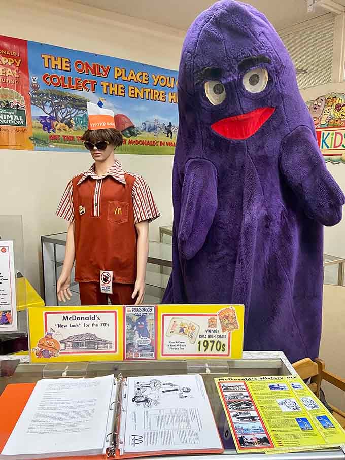 Grimace towers over a vintage uniform like a purple guardian of fast food nostalgia from your childhood memories.