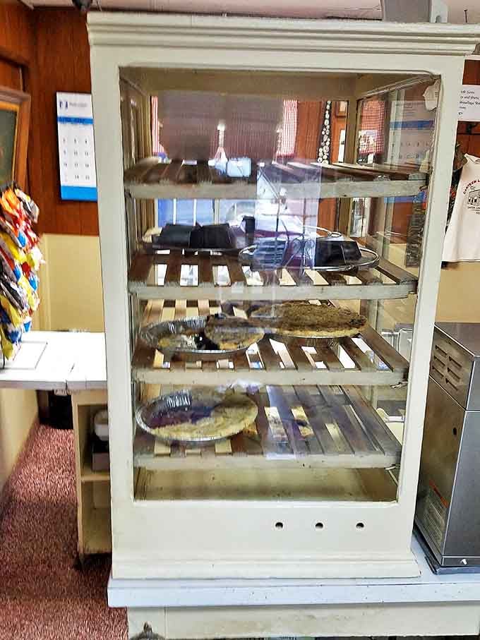 The pie case stands like a museum of Americana, each shelf displaying edible artwork that grandmothers everywhere would applaud.