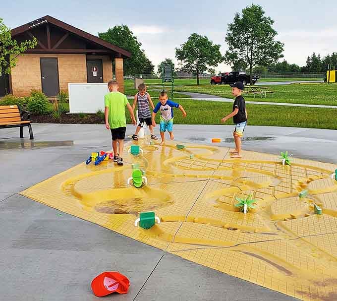 Kids cool off at the splash pad, a vibrant community space in Wausau designed for inclusive and accessible play.