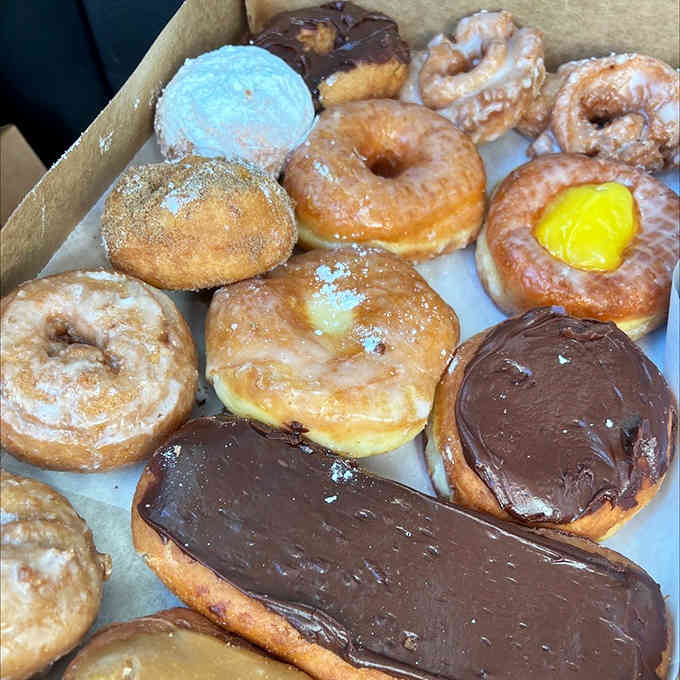 A dozen donuts representing every major food group: glazed, chocolate, filled, and "I'll start my diet tomorrow."