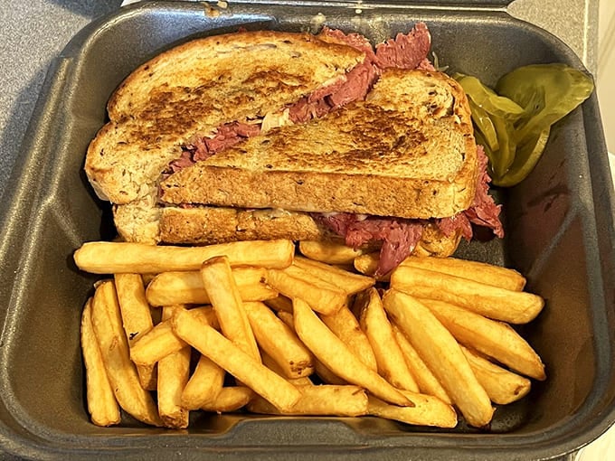 That Reuben is stacked higher than your expectations, and the golden fries are basically edible happiness in stick form.