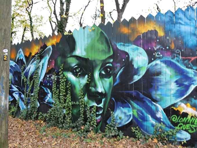 This stunning face emerges from swirling colors, watching over passersby with eyes that seem to follow your every move.