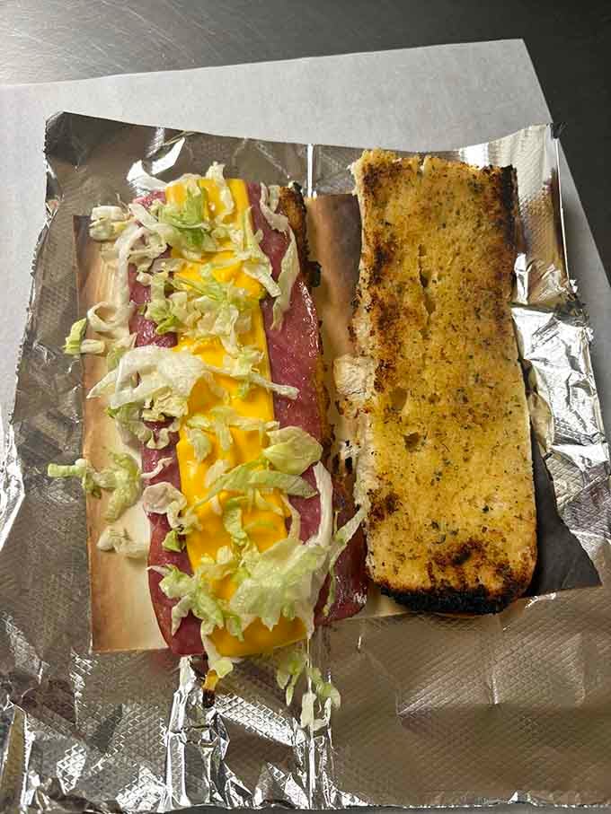 The torpedo sandwich arrives like a submarine docking at your table, loaded with enough toppings to require architectural support.