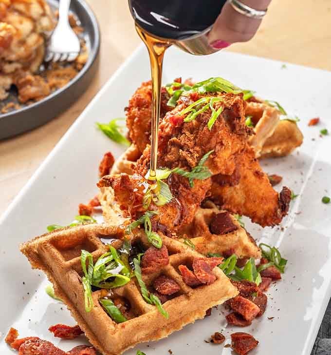 Spicy maple cajun chicken meets crispy waffles in a marriage that would make any brunch lover weep.