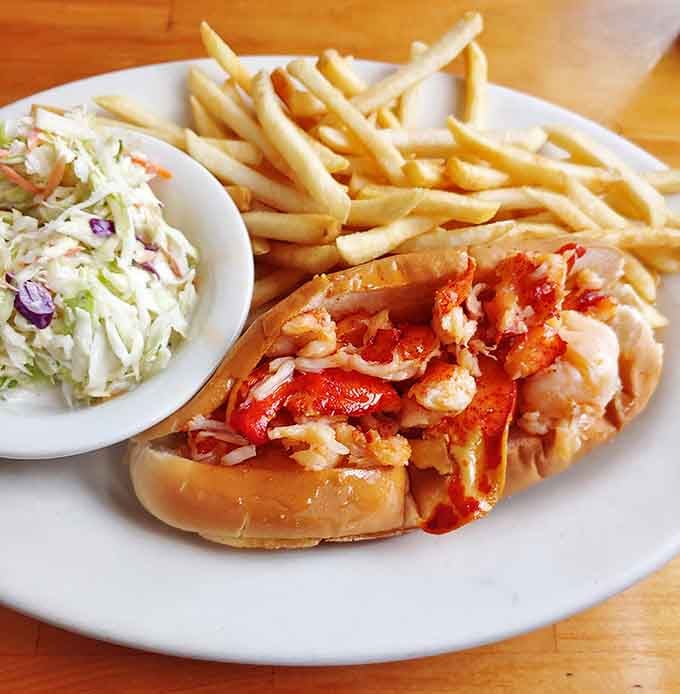 The lobster roll arrives bursting with sweet meat, proving that sometimes the simplest pleasures are the most profound.