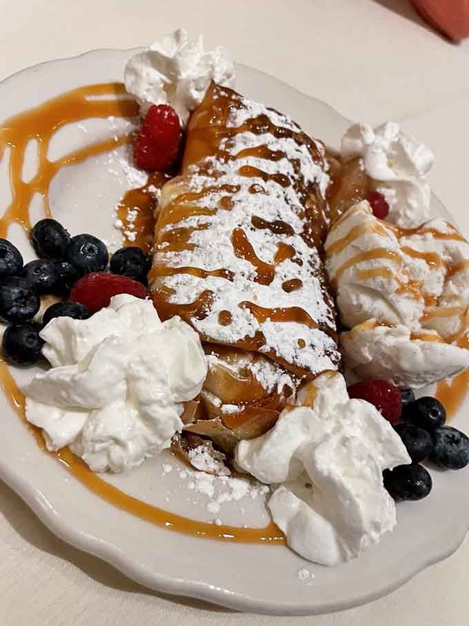 Warm apple strudel draped in caramel, crowned with whipped cream and fresh berries&mdash;dessert doesn't get more indulgent.