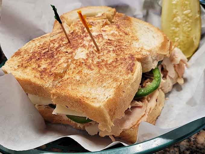 Golden toasted bread barely containing its turkey treasure, proving that sometimes simple perfection needs no introduction or apology.