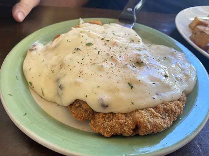 This chicken fried steak drowning in gravy is the kind of plate that makes diets seem irrelevant.