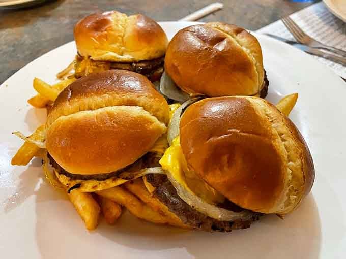 Four cheeseburgers lined up like they're posing for their high school yearbook photo, and they're all valedictorians.
