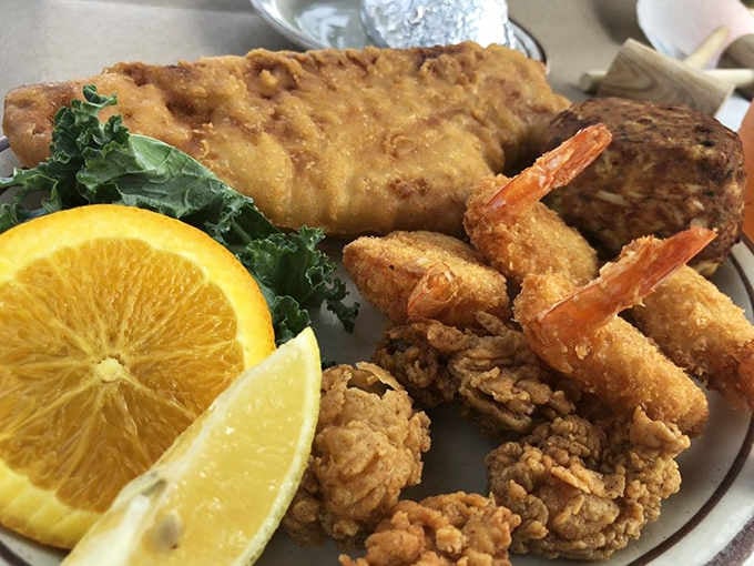 A golden fried seafood platter that looks like it swam straight from the Chesapeake to your plate.