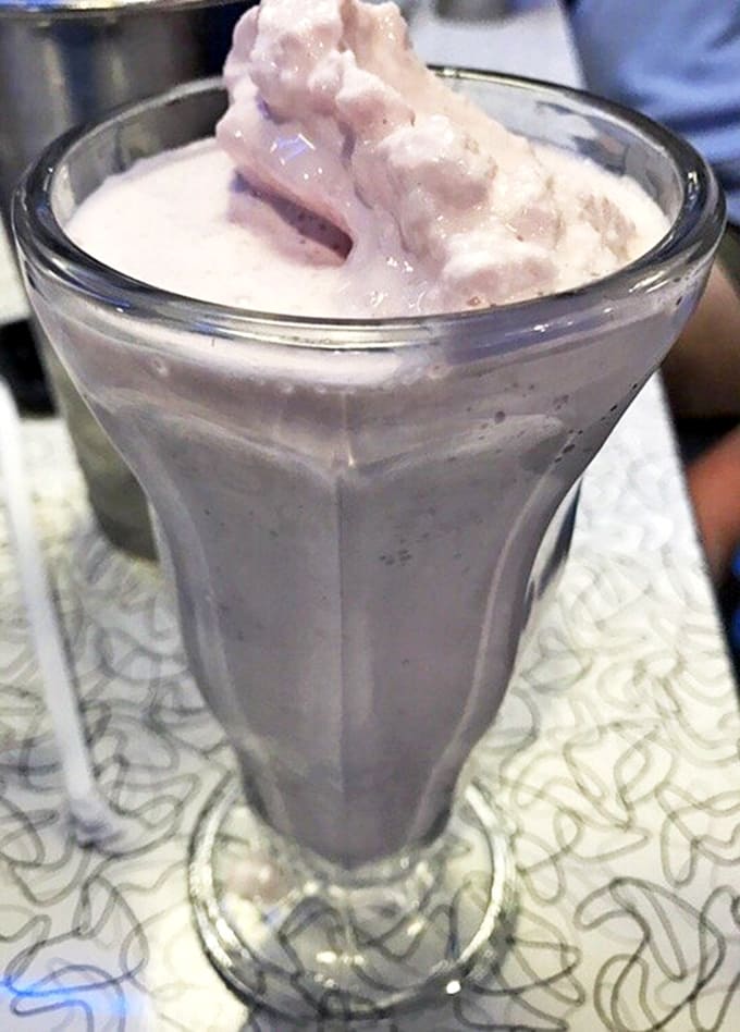 This milkshake doesn't just bring boys to the yard&mdash;it's thick enough to stand your spoon in, a purple cloud of creamy nostalgia served in a glass tall enough to house your ambitions.