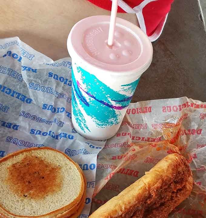 The holy trinity of road food: a classic sandwich, crispy bun, and that iconic cup with the jazz pattern that screams "this drink will be amazing."