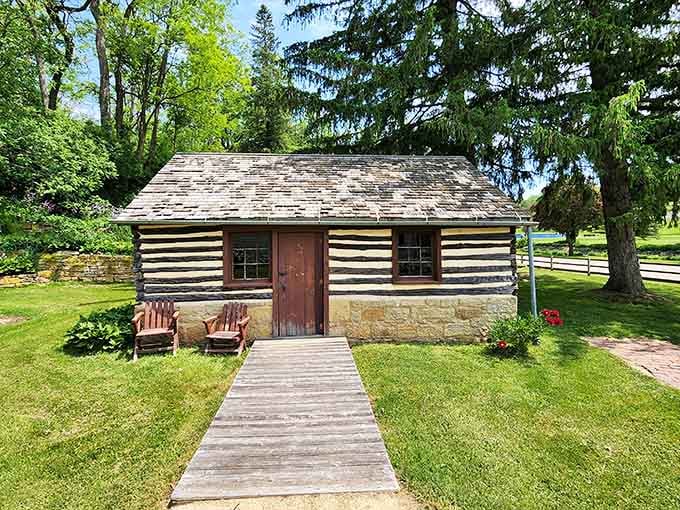This log cabin with stone foundation shows the architectural evolution from frontier practicality to permanent settlement in one building.