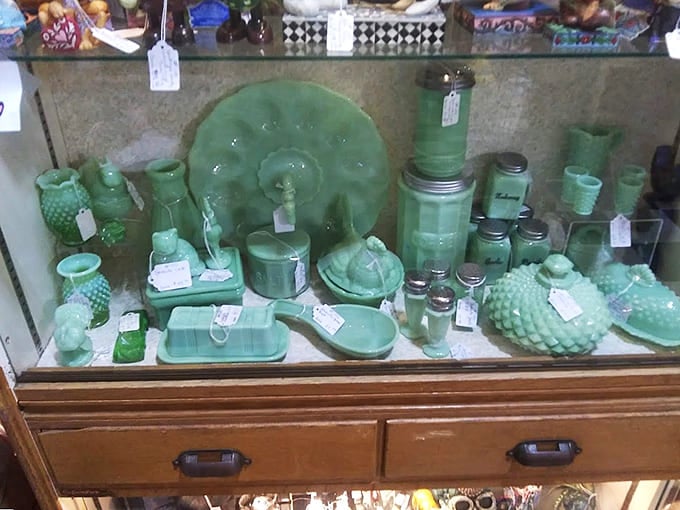 Jadeite glassware collectors, prepare yourselves: this display case is basically your personal Mount Everest of temptation.