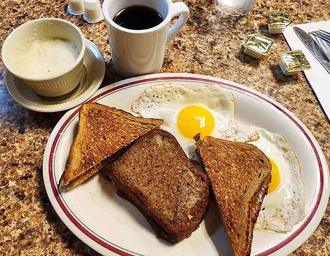 Perfectly golden toast and sunny-side-up eggs: breakfast done right, no architectural plating nonsense required here.