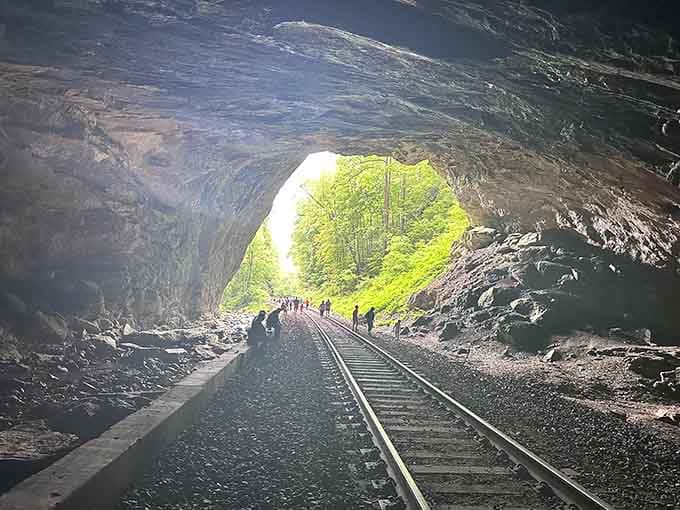 Inside the tunnel, visitors become tiny specks against walls that have witnessed countless centuries pass by.
