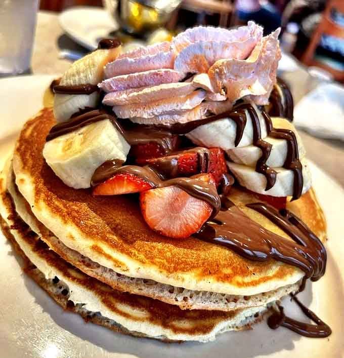These Nutella pancakes stacked with strawberries and chocolate drizzle are basically dessert disguised as breakfast, and nobody's complaining.
