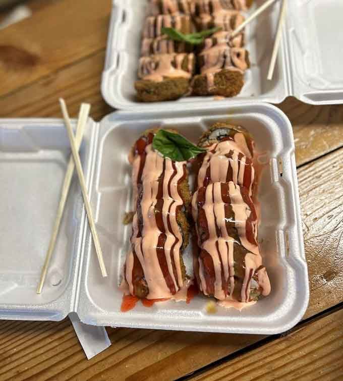 Sushi rolls drizzled with sauce artistry that would make Jackson Pollock hungry and maybe a little jealous too.