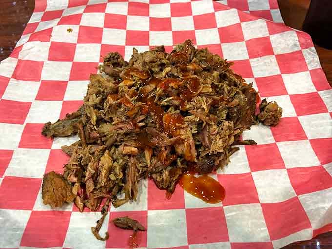 Pulled pork in its natural habitat: a red-and-white checkered paper that's about to become the happiest napkin in Kentucky.