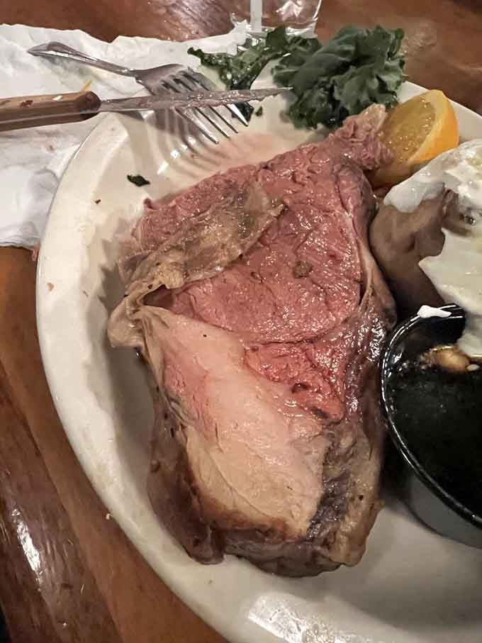 The prime rib glistens like a ruby, sliced thick and cooked to rosy perfection that would make any carnivore weep.