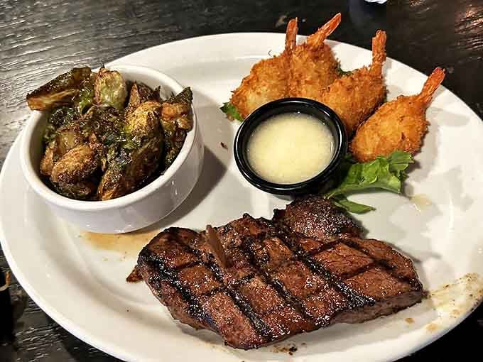 The perfect surf and turf trifecta: perfectly grilled steak, golden shrimp, and Brussels sprouts that might convert vegetable skeptics.