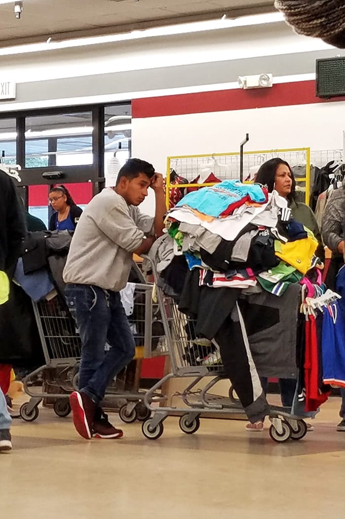 When shopping carts overflow like this, you know someone's discovered the thrill of thrift store mathematics: more stuff, less money.