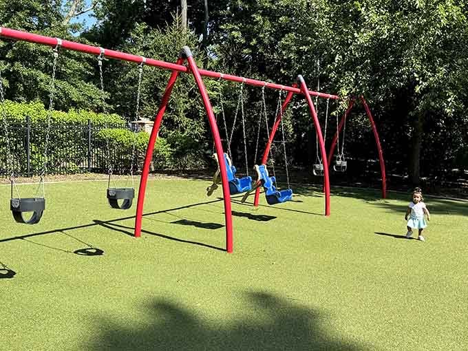 Traditional red swings never go out of style, especially when surrounded by such thoughtful park design.